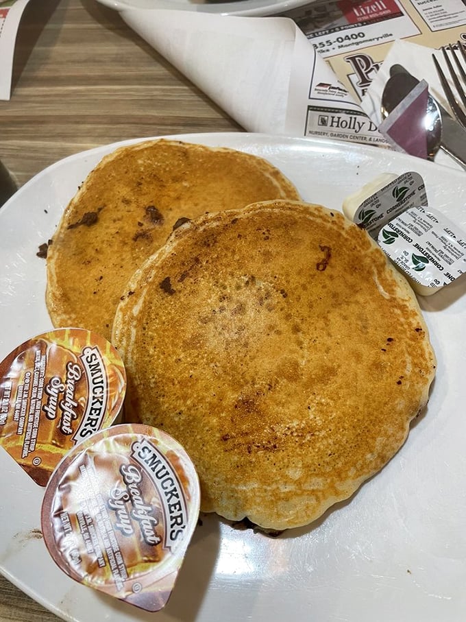 Pancakes so fluffy they practically hover above the plate. The butter melts into little pools of breakfast bliss.