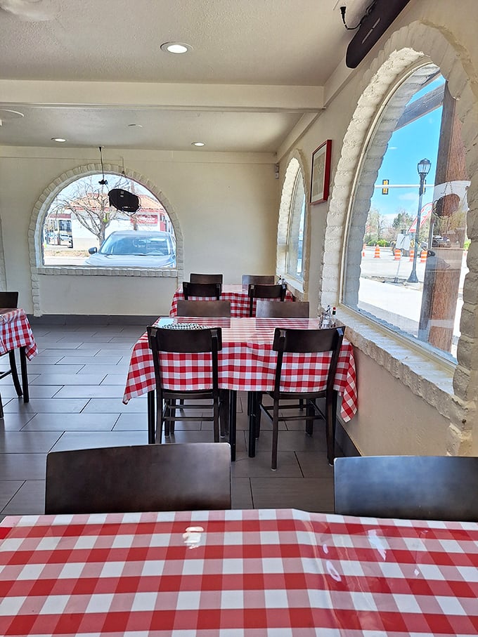 Empty tables waiting for the lunch rush—each one a stage where cheesy dramas of deliciousness will soon unfold.