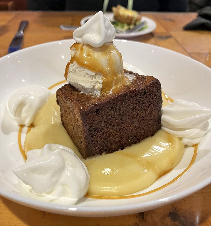 Sticky toffee pudding swimming in custard – proof that the British actually do understand dessert, despite centuries of culinary rumors to the contrary.