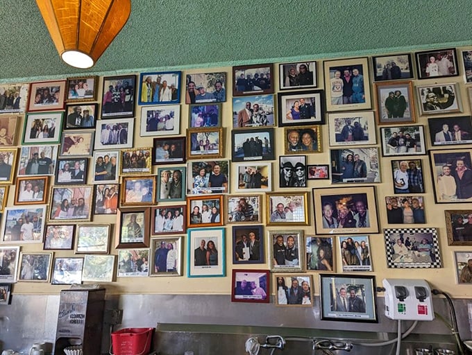 A wall of fame that tells the restaurant's story better than words ever could—each photo a chapter in Oakland's culinary history.