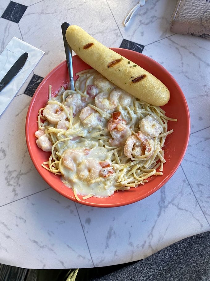 Pasta Alfredo with shrimp that would make an Italian grandmother nod in approval. The garlic bread isn't just a side – it's an essential tool.