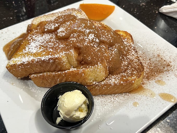French toast that's dressed for success—cinnamon-dusted, powdered-sugar-kissed, and ready for its maple syrup baptism.