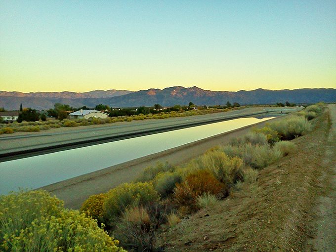 The California Aqueduct brings life-giving water through the desert, reflecting sunsets that would make even a Hollywood set designer jealous.