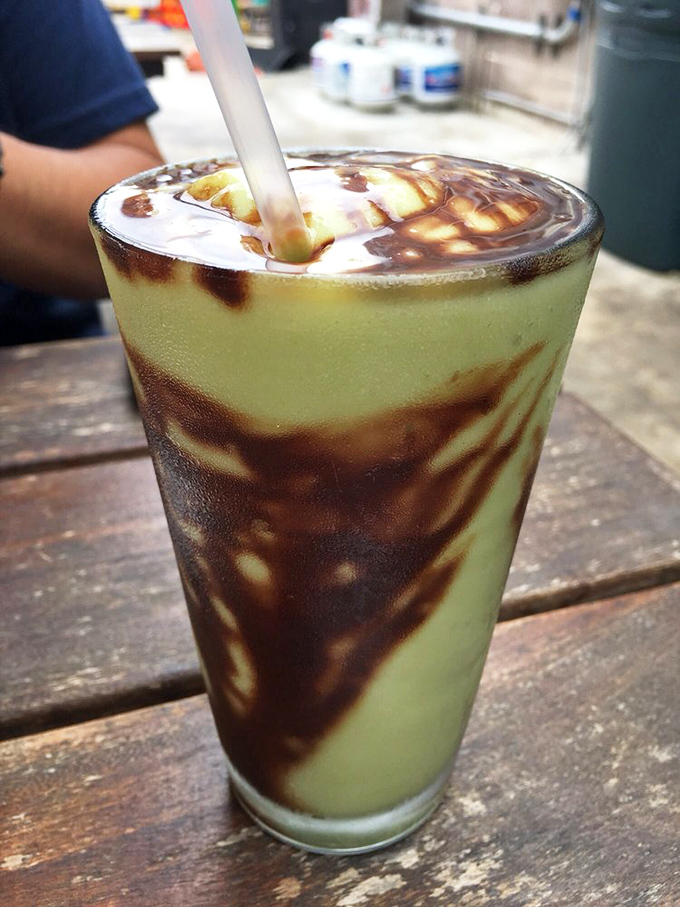 This isn't just a milkshake—it's modern art. Swirls of chocolate sauce transform a creamy avocado shake into a drinkable Jackson Pollock.