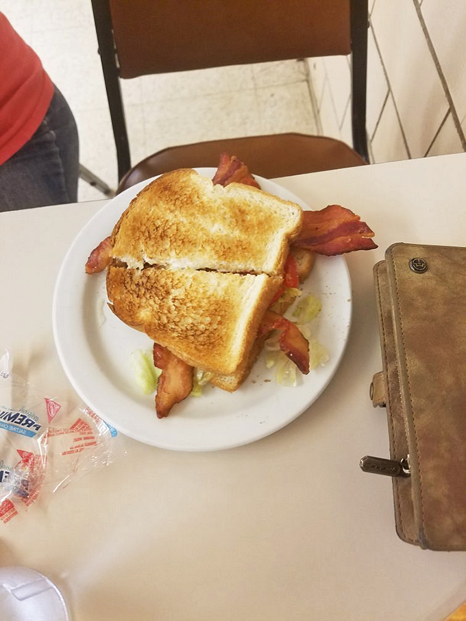 A BLT that understands the importance of the "B"—bacon hanging rebelliously over perfectly toasted bread. Sandwich perfection doesn't need to be complicated.