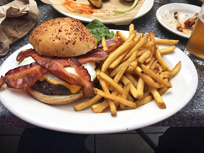 This isn't just a burger—it's architecture. The bacon forms perfect arches over melted cheese, creating a monument to American ingenuity.