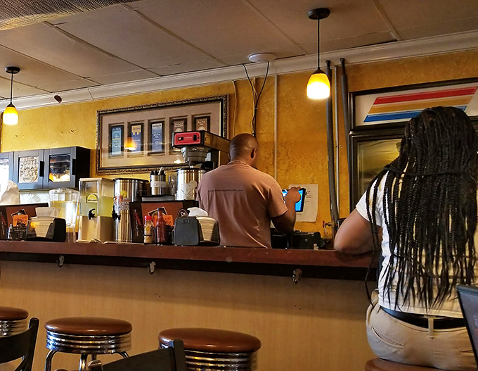 The counter where magic happens. Notice how everyone's focused on their food? That's not rudeness—that's respect for the craft.