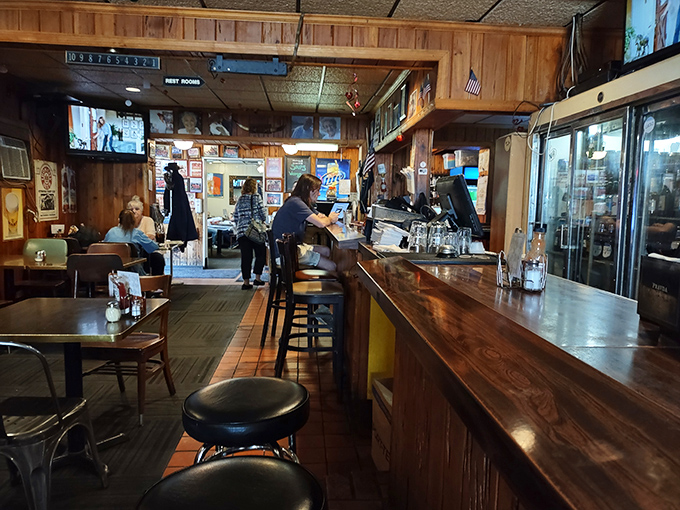 The bar area—where Pittsburgh sports play on TV, regulars exchange neighborhood news, and first-timers become converts over cold beer and hot food.