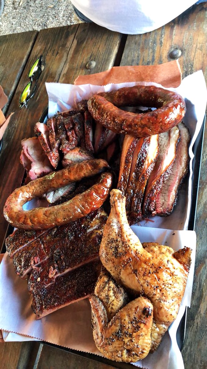 A barbecue sampler that's less a meal and more a religious experience – the kind of platter that makes vegetarians question their life choices.