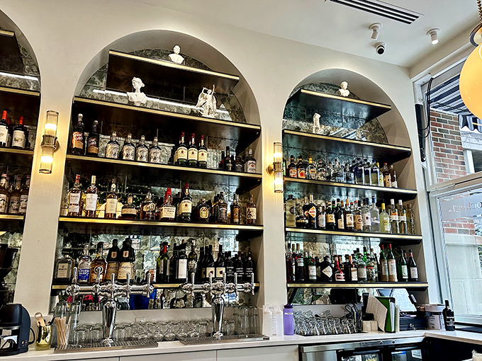 Behind these arches lies liquid inspiration—a library of spirits where every bottle tells a different story.