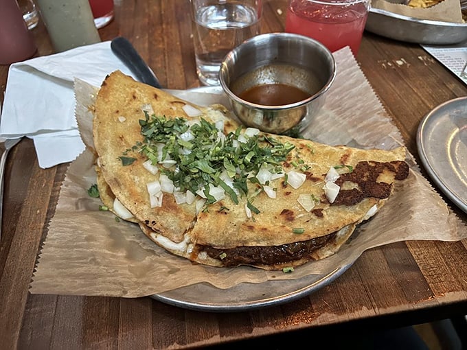 This quesadilla isn't just folded – it's transformed into a golden half-moon of cheese-filled bliss that makes you question all other quesadillas you've known.