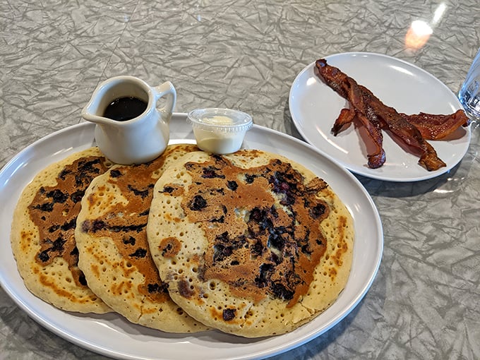 Blueberry pancakes with a side of bacon – the perfect sweet-savory partnership that's been making mornings better since time immemorial.