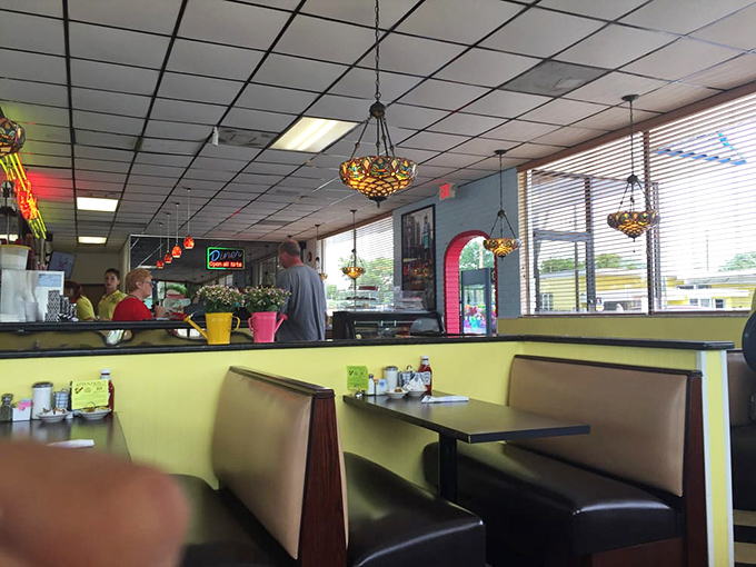 Cozy booths where countless coffee refills and life stories have been shared—the yellow walls practically radiating Florida sunshine.