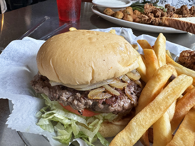 This isn't just a burger—it's a hand-formed masterpiece topped with grilled onions that have achieved perfect caramelization nirvana.
