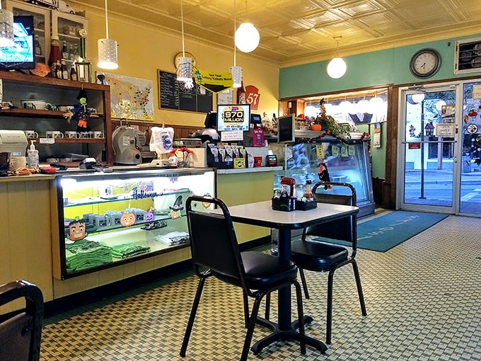 The counter view reveals the diner's beating heart – display case of treats, vintage memorabilia, and the promise of homestyle cooking just steps away.