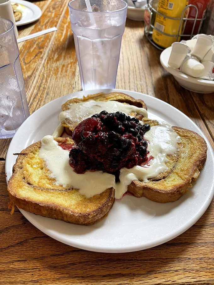 French toast that's having an identity crisis as cheesecake – and we're completely fine with that. The berry topping adds a perfect tart contrast.