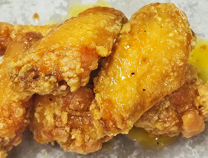 Sauce-slathered wings glistening with promise. These aren't just wings—they're flavor vehicles delivering sweet heat straight to your happiness receptors.