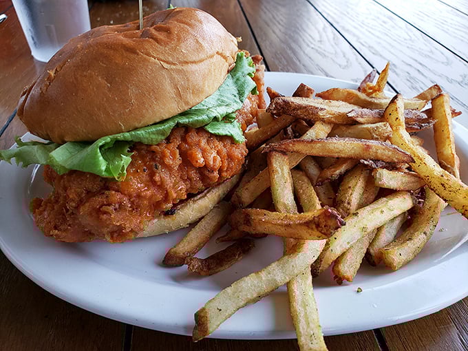 A chicken sandwich that's dressed for success—crispy, juicy, and ready for its close-up, with a side of hand-cut fries.