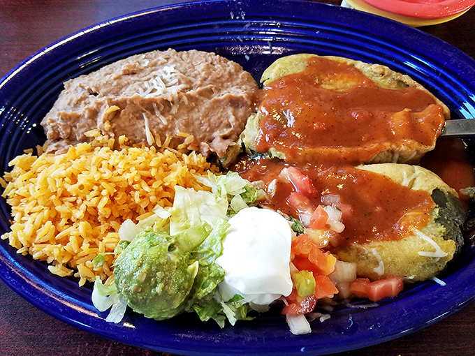 The Chile Relleno isn't just stuffed—it's fulfilled. This plate delivers the holy trinity of Mexican comfort: perfectly seasoned rice, velvety beans, and cheese-filled chile.