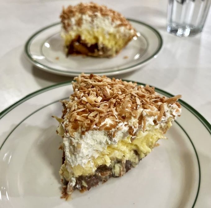 The coconut cream pie topped with toasted coconut flakes isn't trying to reinvent dessert – it's reminding you why classic desserts became classics in the first place.