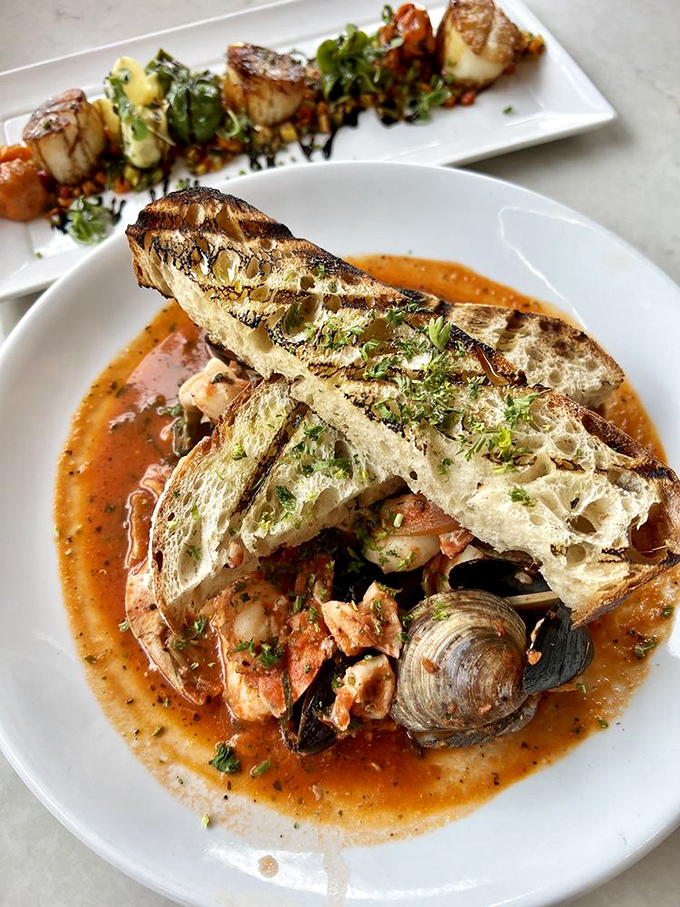 Another angle on that magnificent cioppino—where tomato broth becomes a hot tub for the ocean's most delicious residents.