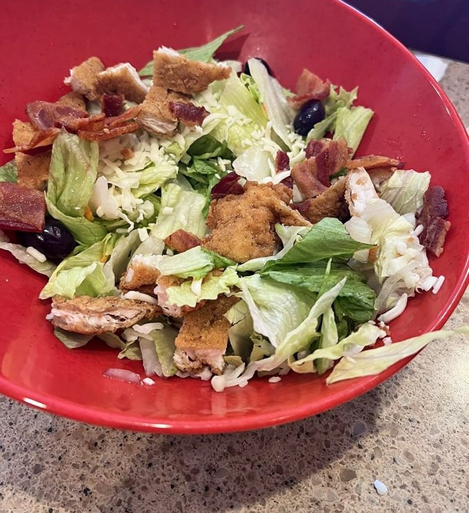 This isn't just a salad—it's a carefully constructed garden of crunch, featuring fresh greens, savory bacon, and golden croutons in perfect proportion.