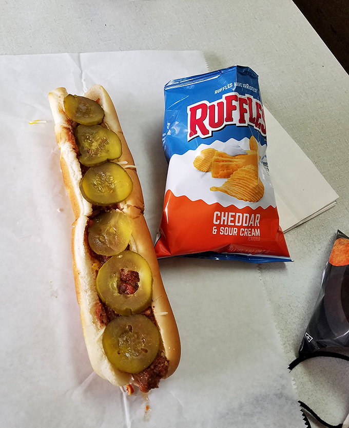 The perfect pairing – a sauce-laden dog and crispy chips create the kind of lunch that makes afternoon meetings mysteriously disappear from calendars.