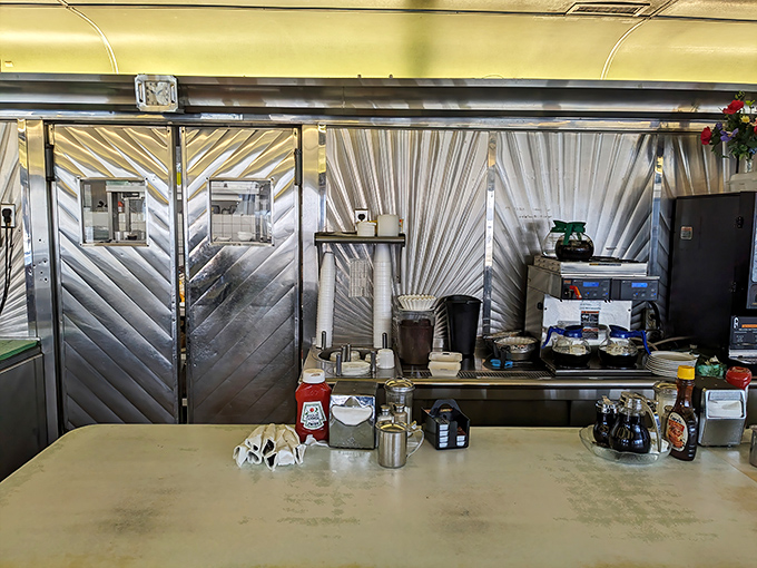 The stainless steel kitchen backdrop creates the perfect stage for the daily performance of eggs cracking, bacon sizzling, and coffee pouring.