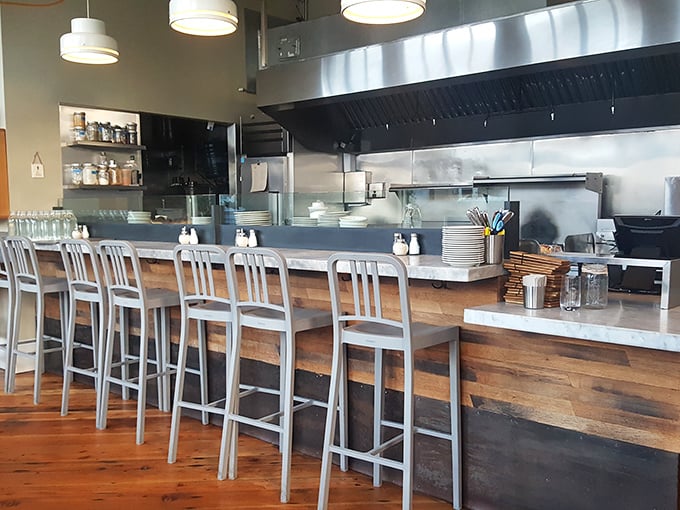 Counter seating: where solo diners become breakfast voyeurs, watching culinary magic happen just feet away from their coffee cups.