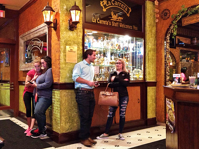 The bar area welcomes patrons with the promise of tequila treasures and conversation – the ultimate Mexican hospitality.