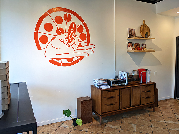 That logo says it all. The hand-tossing pizza dough mural watches over the mid-century modern furniture like a delicious guardian angel.
