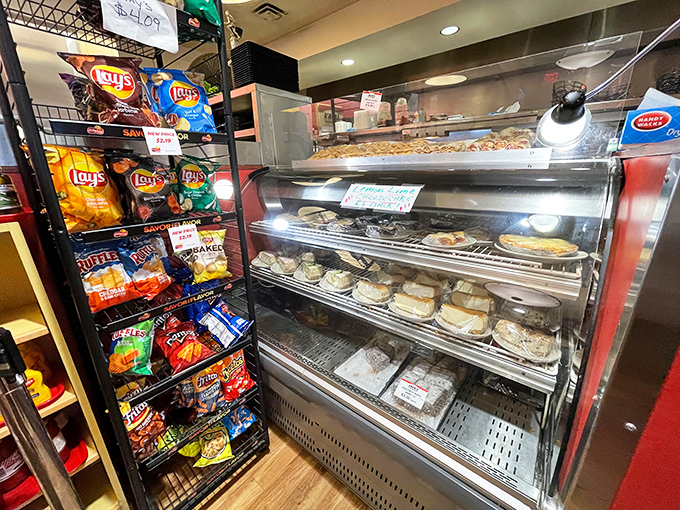 The dessert case stands guard next to chip racks—ensuring your meal can end with either a sweet symphony or a salty crunch.