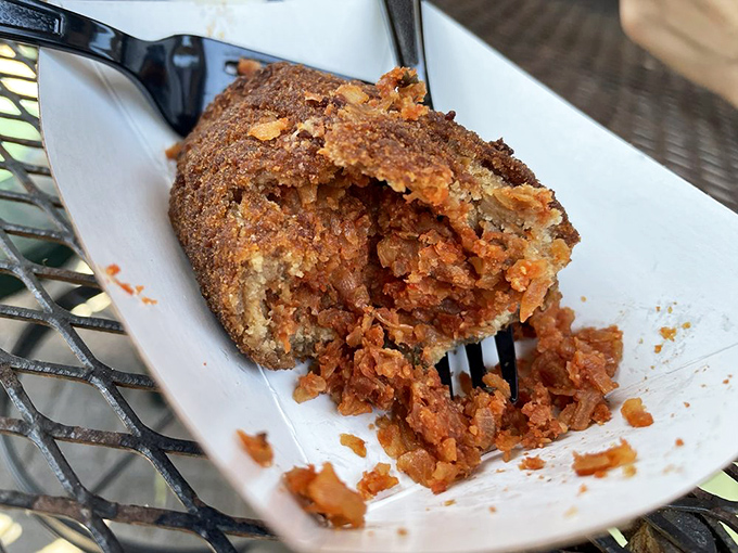 The devil crab's crispy exterior gives way to spicy, savory filling—like biting into a little piece of Tampa Bay history with a kick.