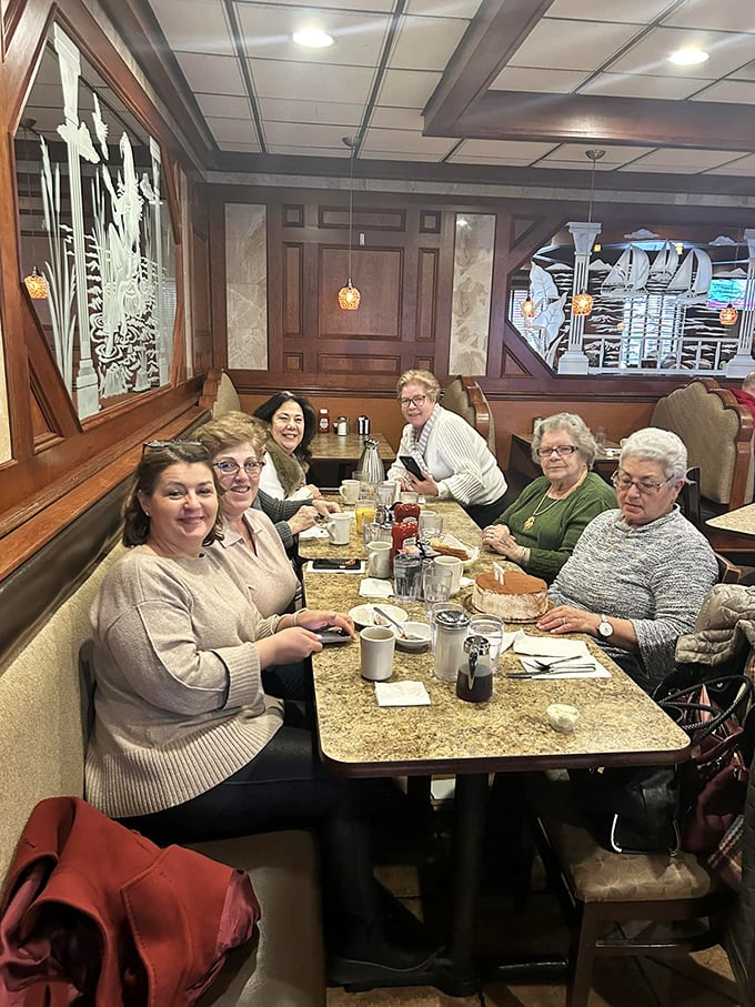 A gathering of friends around a diner table – proof that the best social network has always been the one that comes with coffee and conversation.