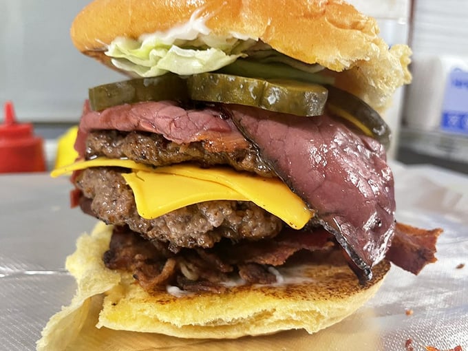 This burger defies both gravity and restraint—pastrami and bacon creating a meaty masterpiece. 