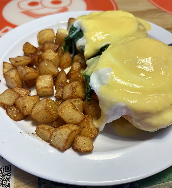 Eggs Benedict that balances decadence with technical precision. That hollandaise sauce is sunshine yellow for a reason—it's bringing brightness to your morning.