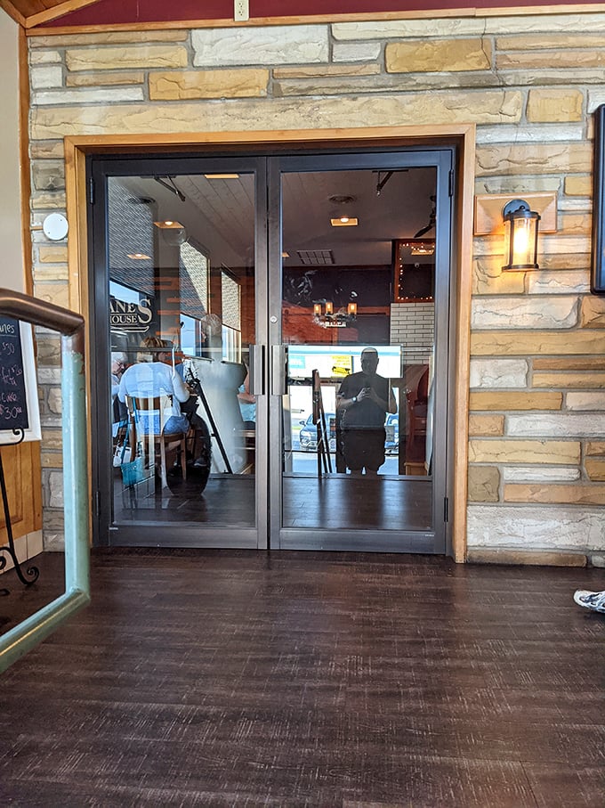 The entrance beckons with warm lighting and stone details—like a portal to a world where calories don't count and decisions only involve what to order.