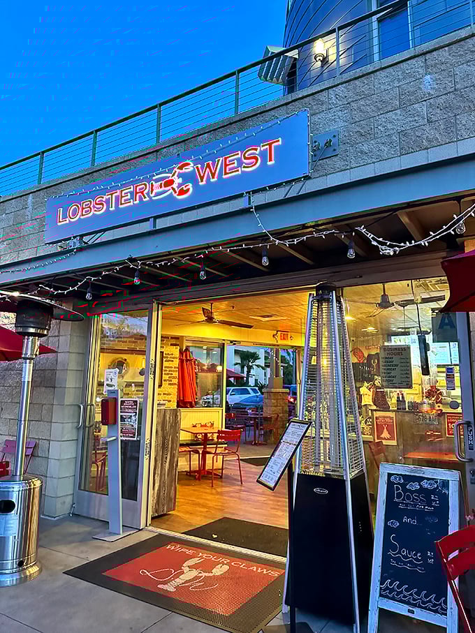 As evening approaches, the welcoming glow of Lobster West beckons seafood lovers. The "Happy with your claws" doormat sets the tone for the experience ahead.