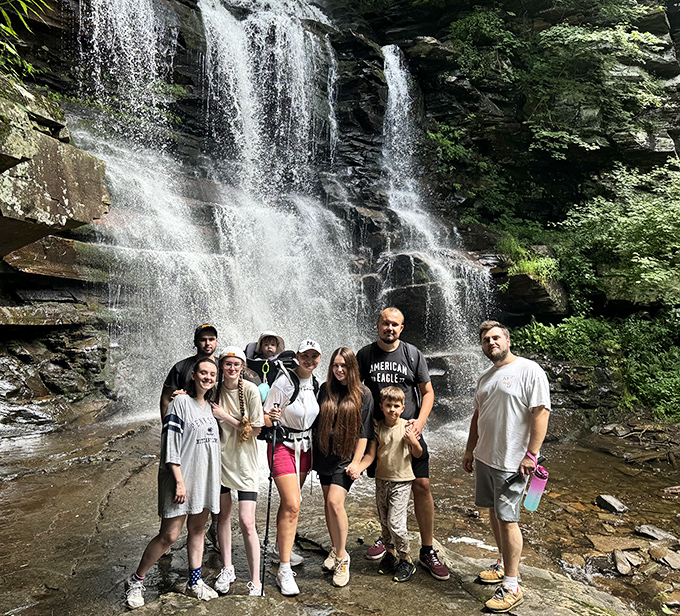The universal expression of waterfall joy – that moment when the hike's effort pays off with nature's most spectacular show-and-tell.