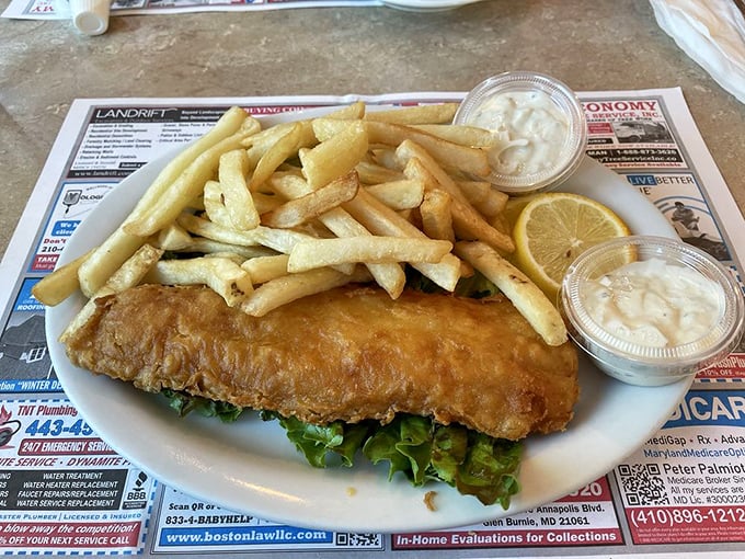 Fish and chips that would make a British pub jealous, served on placemats that give you something to read between bites.