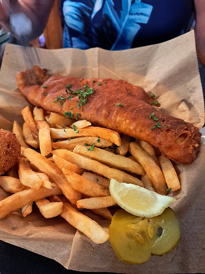 This fish and chips doesn't just satisfy hunger—it settles the eternal debate of whether seafood tastes better when wrapped in newspaper-lined baskets. (It does.)