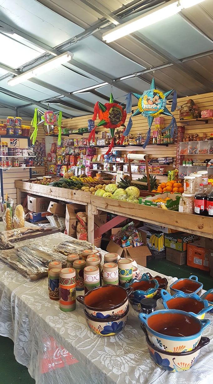 Produce meets piñatas in this sensory wonderland. Fresh fruits and vegetables share space with colorful pottery, proving that practical and whimsical can coexist beautifully.
