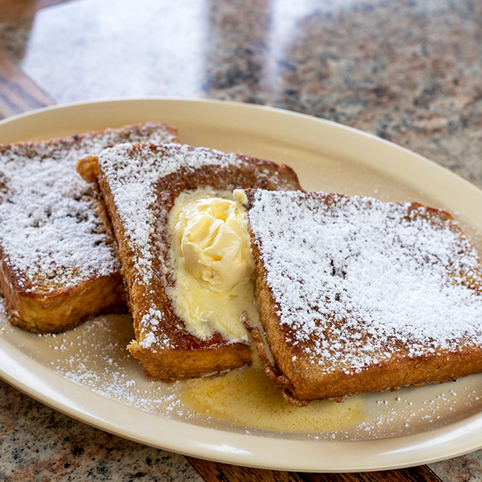 French toast that's actually French in spirit—indulgent, unapologetically buttery, and dusted with powdered sugar like a Parisian snowfall.