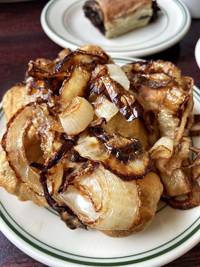These aren't just fried onions – they're caramelized flavor bombs waiting to elevate whatever they touch to legendary status.