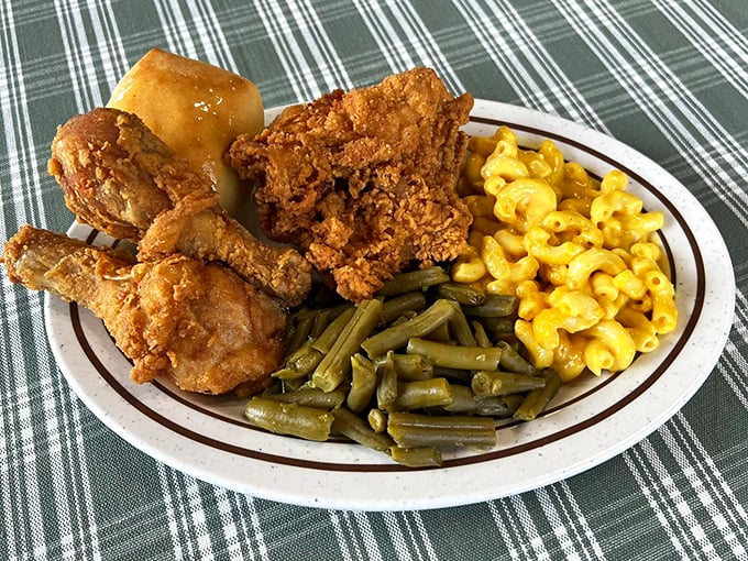 Fried chicken with a crust that shatters like your diet resolutions. Paired with mac and cheese that glows like Southern sunshine.