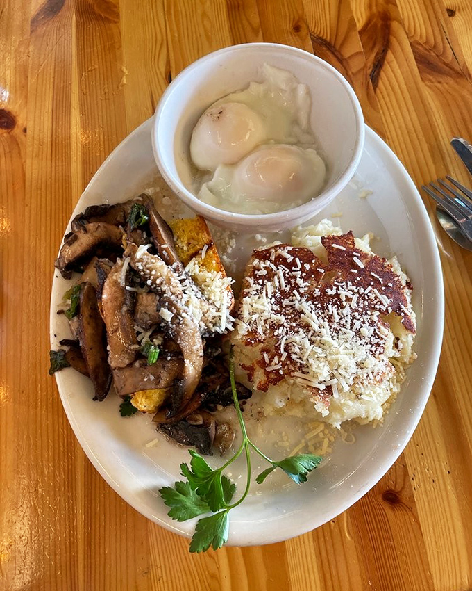 A plate that tells a story of culinary creativity—poached eggs, sautéed mushrooms, and what appears to be cheesy polenta creating a breakfast symphony.