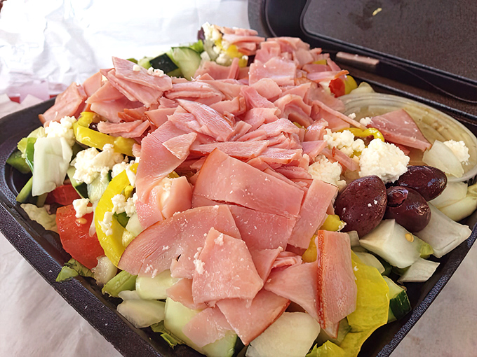 This Greek salad isn't just a healthy option—it's a colorful festival of vegetables crowned with generous ham. Mediterranean meets Florida.