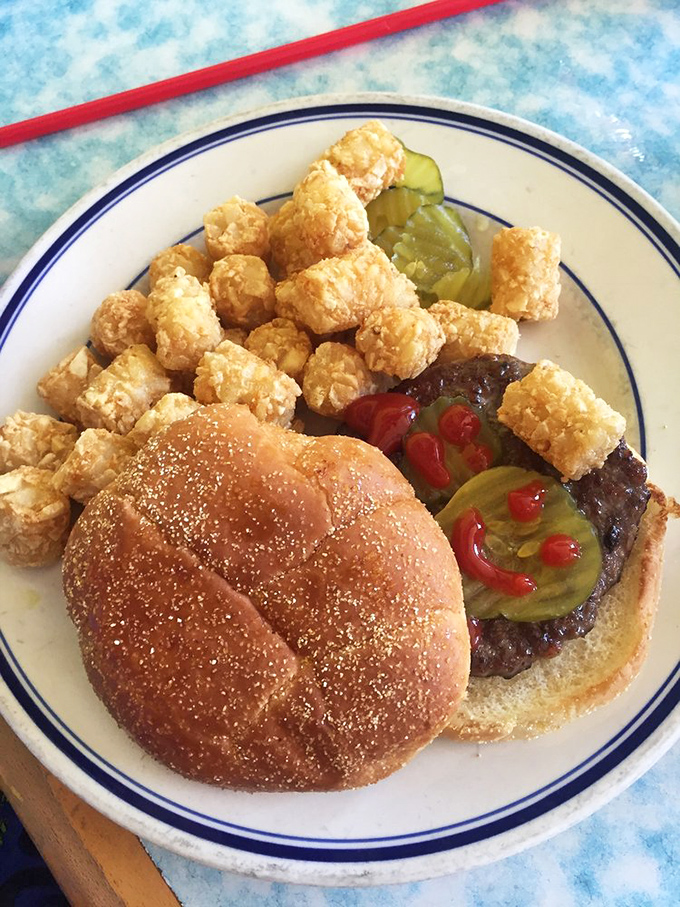 This burger with tots isn't trying to be Instagram famous—it's too busy being delicious in real life.