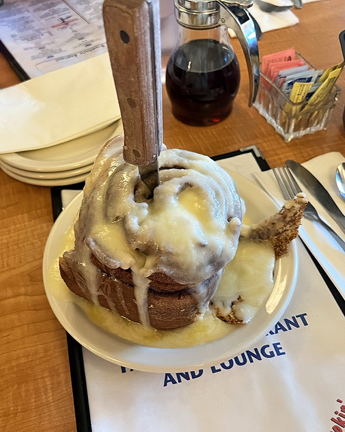 The cinnamon roll—a spiral-bound love letter to butter and cinnamon, wearing its glaze like a prom queen's tiara.