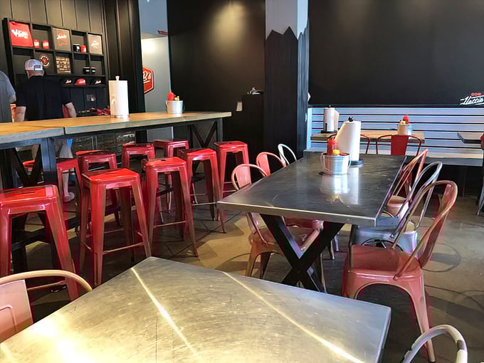 Industrial meets inviting with metal chairs and wooden tables—the perfect backdrop for the spice drama about to unfold.
